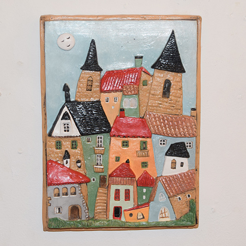 Ceramic tile with landscapes in relief.