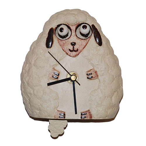 Wall clock in the shape of a sheep made of ceramic.